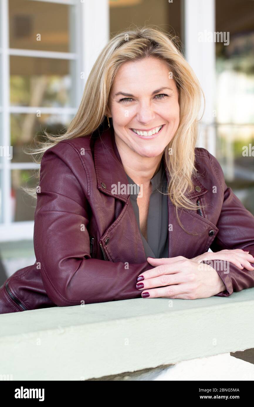 Portrait of a confident woman smiling outside Stock Photo - Alamy