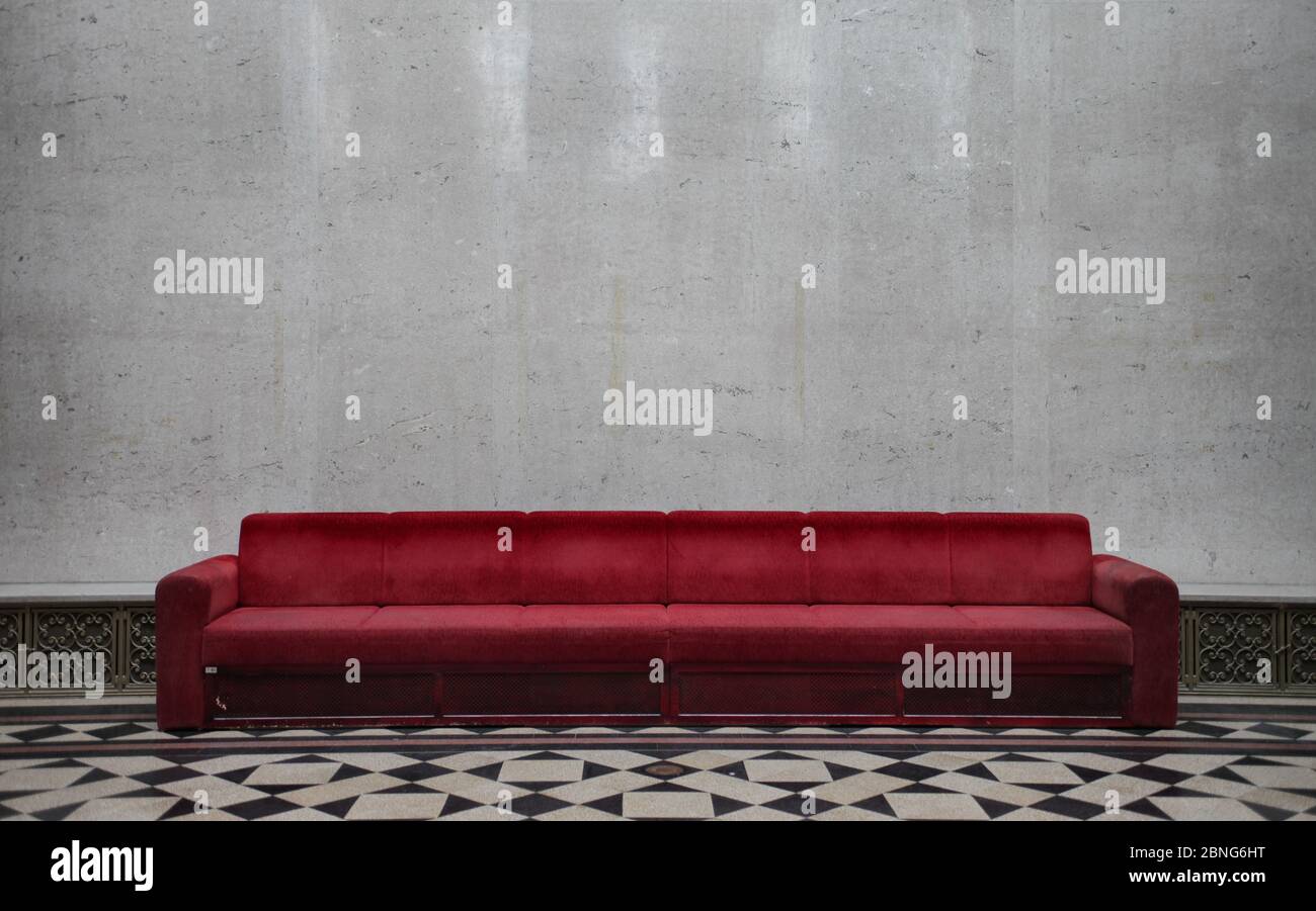 Red sofa in the room with patterned floor Stock Photo - Alamy