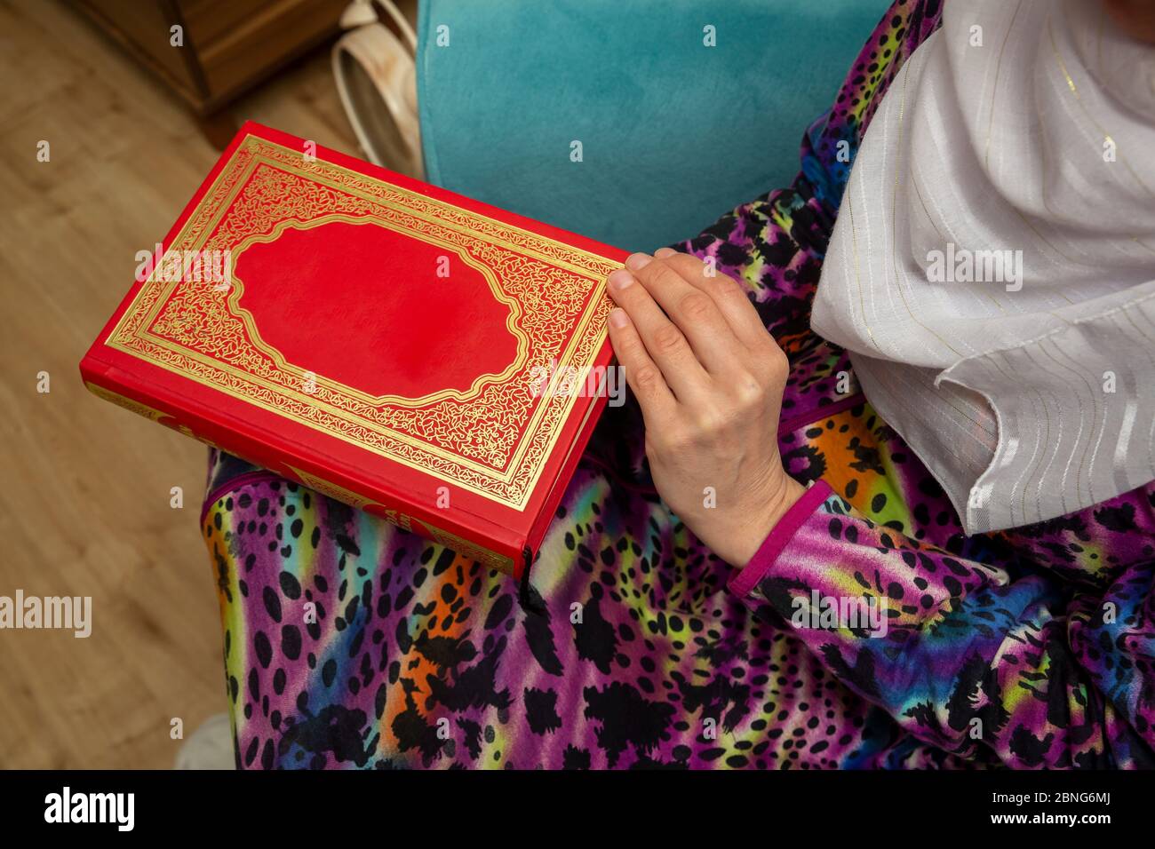 hand holding Quran book Stock Photo - Alamy