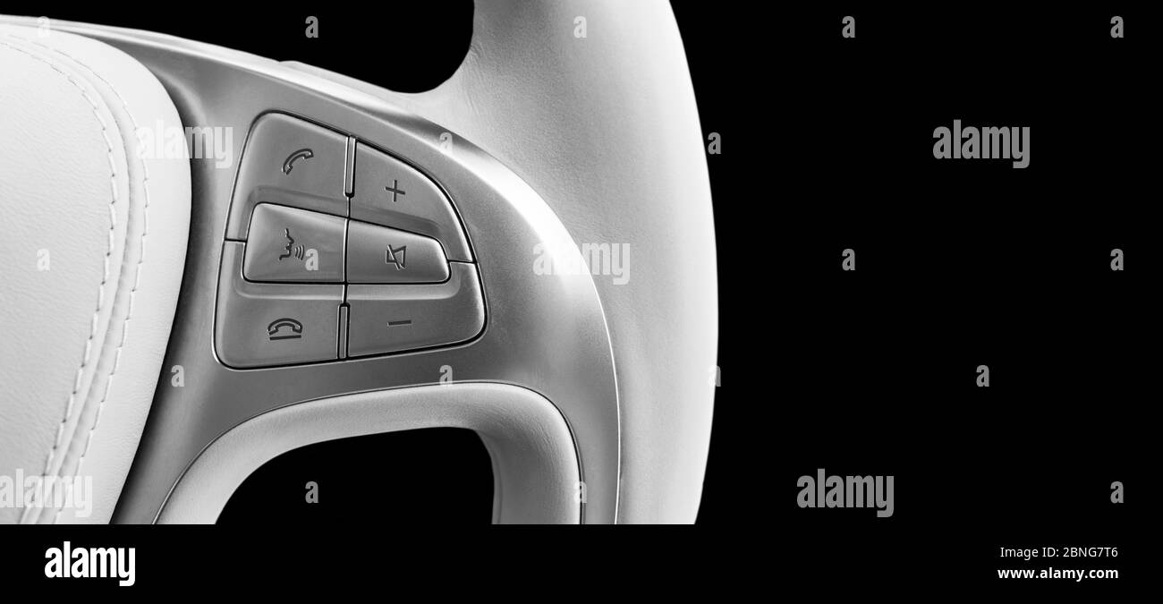 Hands free and media control buttons on the white leather steering ...