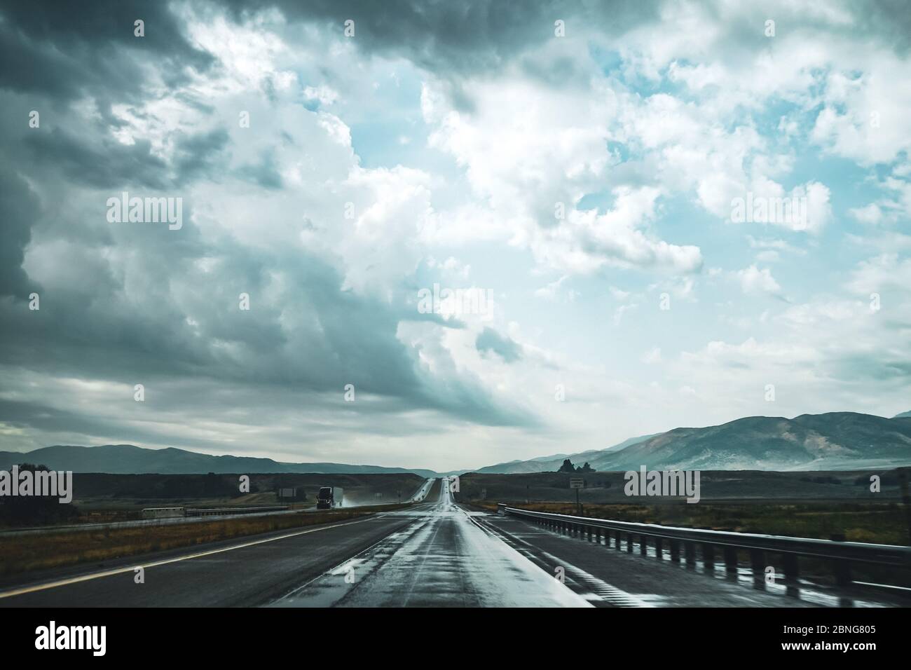 Beautiful of an empty highway road surrounded by hills under a cloudy ...
