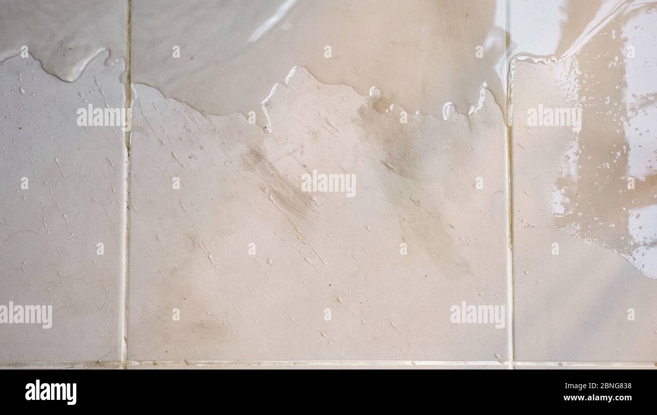 transparent water spreads across floor white tile top view Stock Photo ...