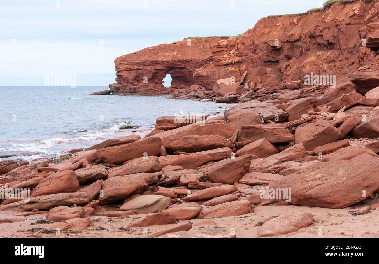 Natural arch among sandstone cliffs. Coastal erosion on Prince Edward ...