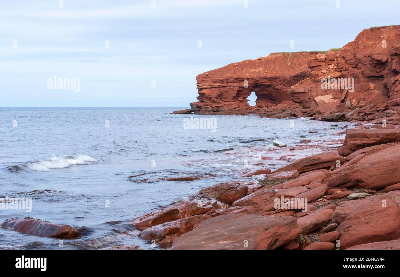 Natural arch among sandstone cliffs. Coastal erosion on Prince Edward ...