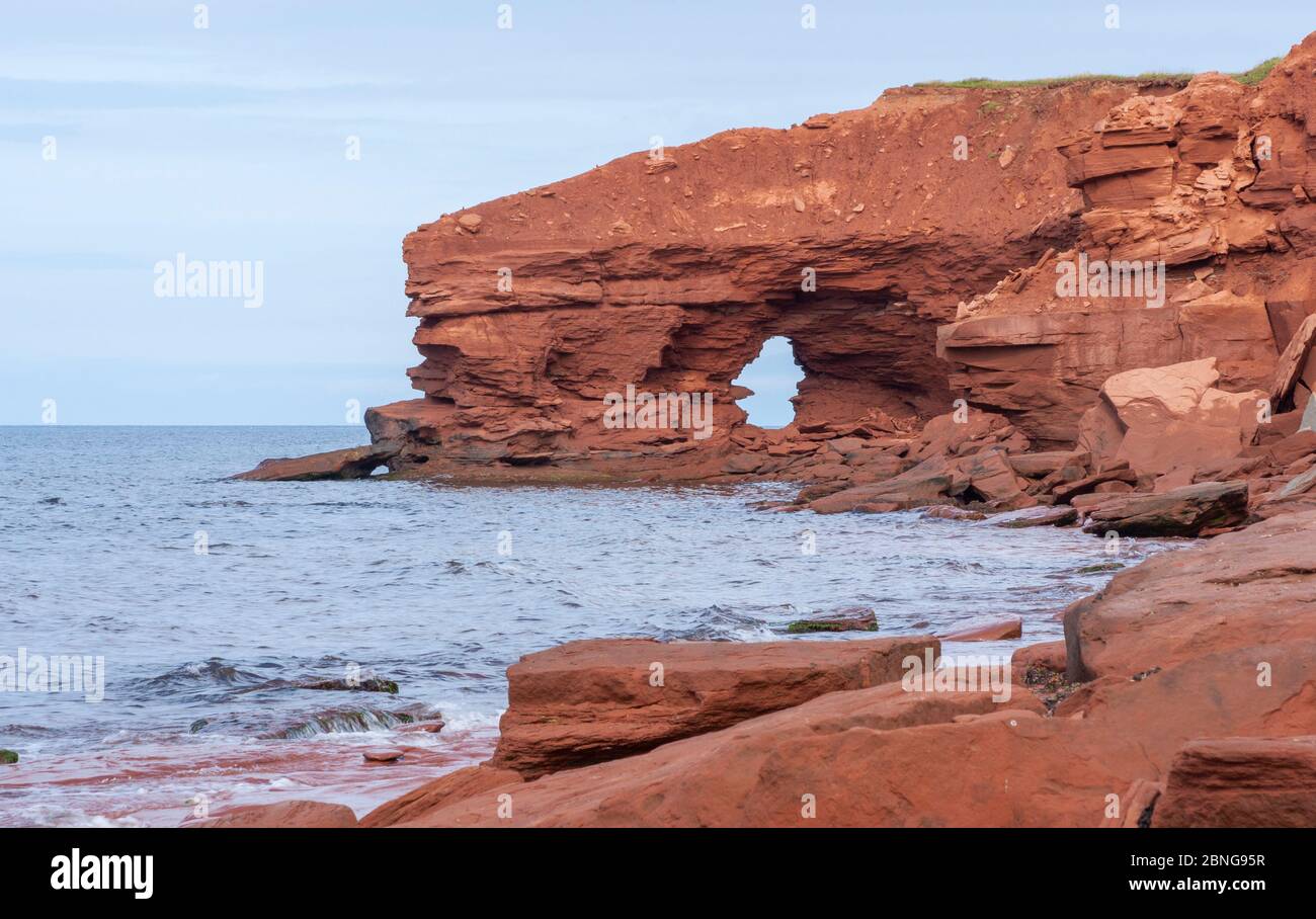 Natural arch among sandstone cliffs. Coastal erosion on Prince Edward ...