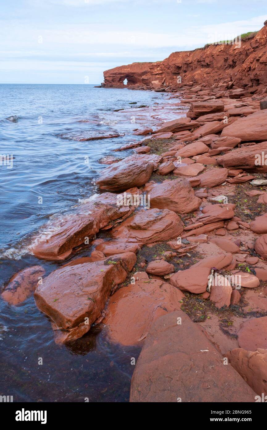 Natural arch among sandstone cliffs. Coastal erosion on Prince Edward ...