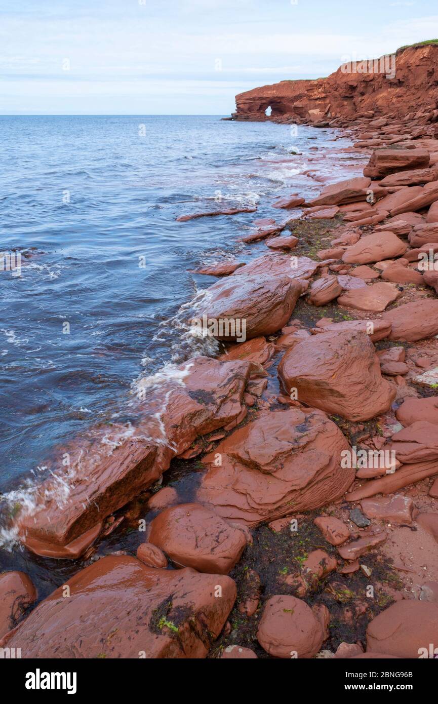 Natural arch among sandstone cliffs. Coastal erosion on Prince Edward ...