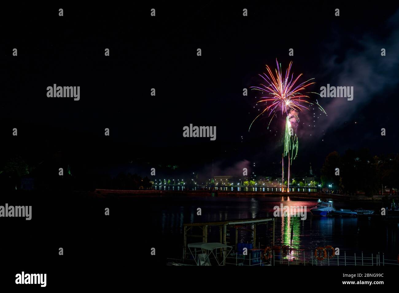 Beautiful view of the colorful fireworks over a city in the night sky ...