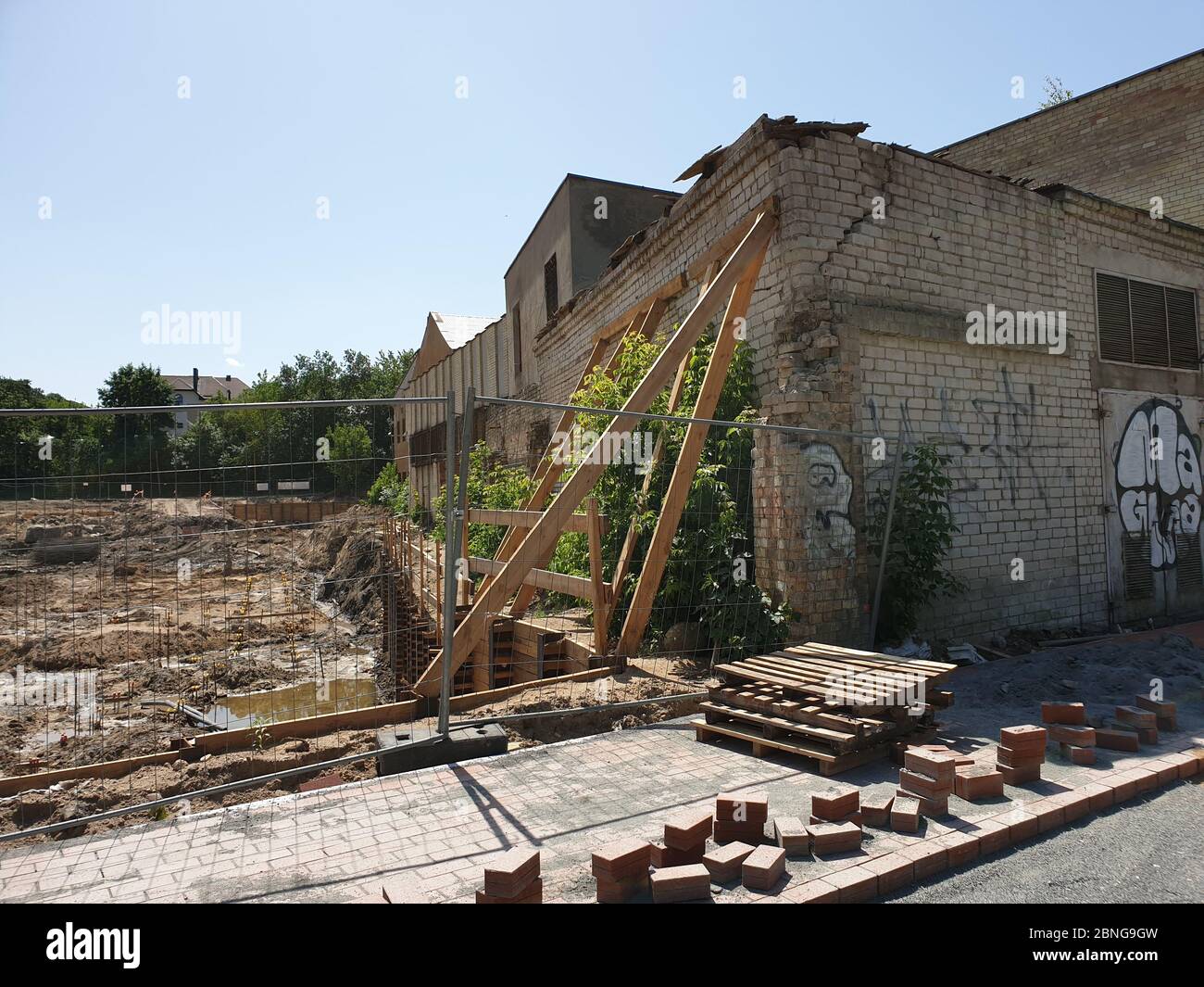 Old abandoned building collapsing near construction site Stock Photo ...