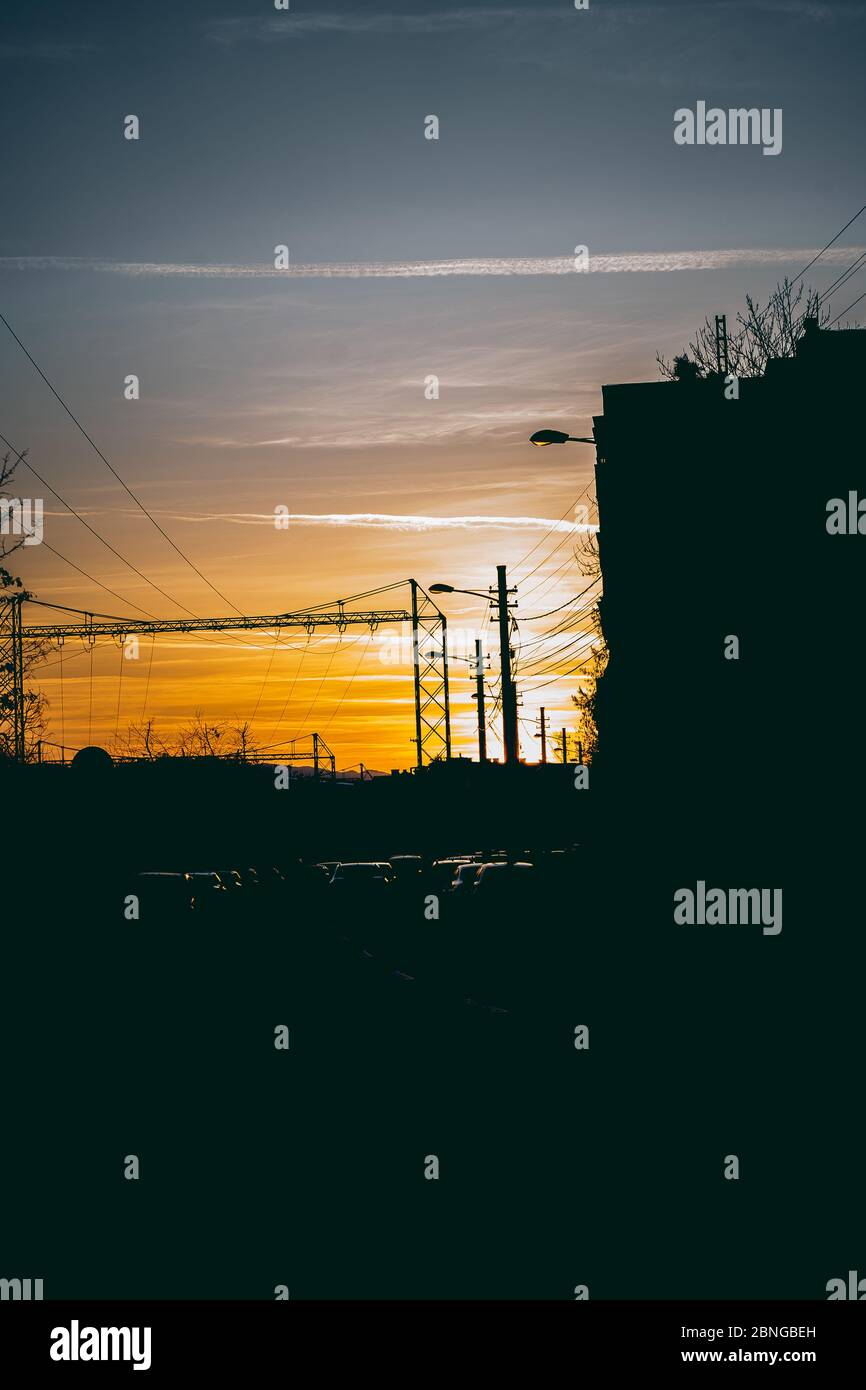 Vertical shot of the silhouette of the buildings with the sunset in the ...