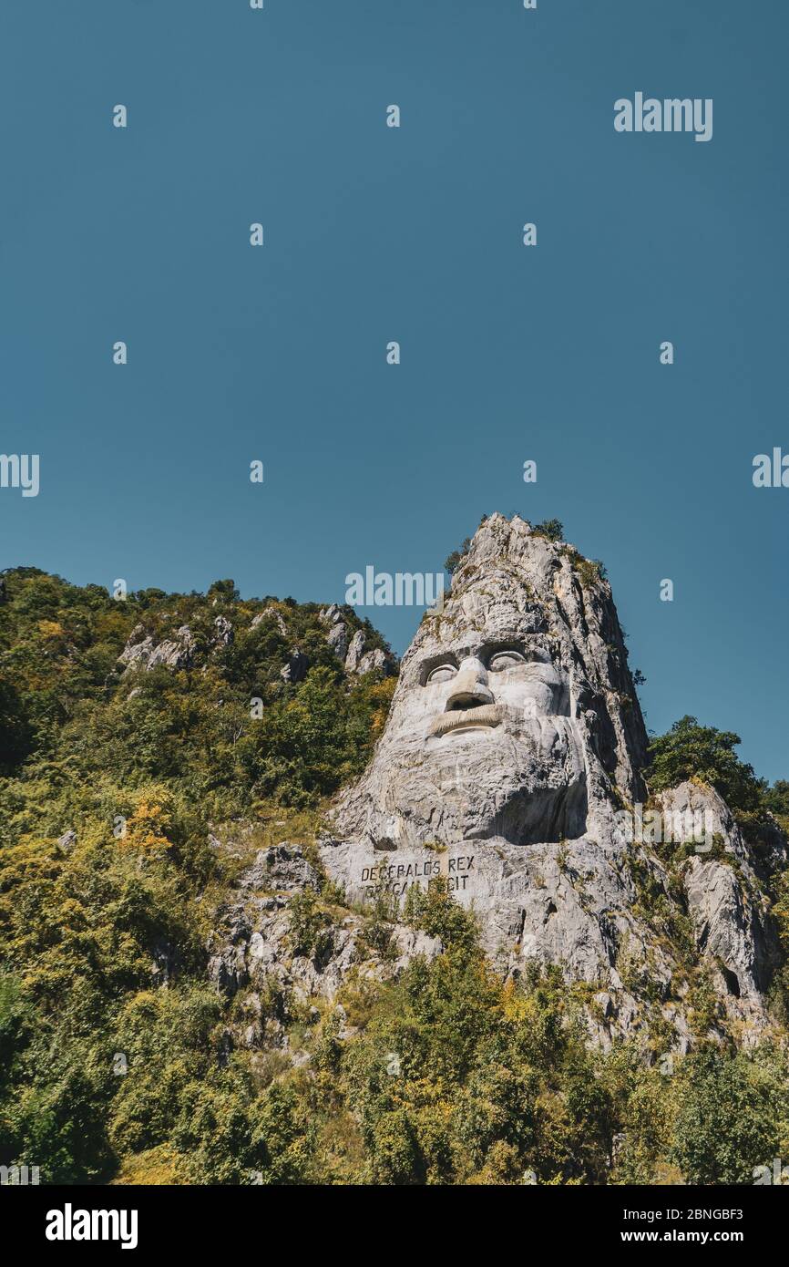 Vertical low angle shot of the magnificent Rock Sculpture of Decebalus ...