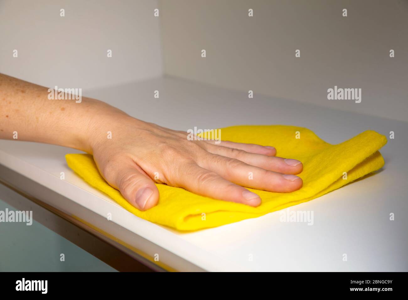 cleaning furniture with yellow cloth Stock Photo - Alamy