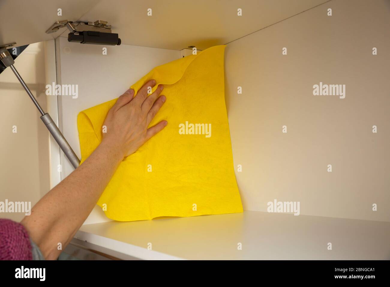 cleaning furniture with yellow cloth Stock Photo - Alamy