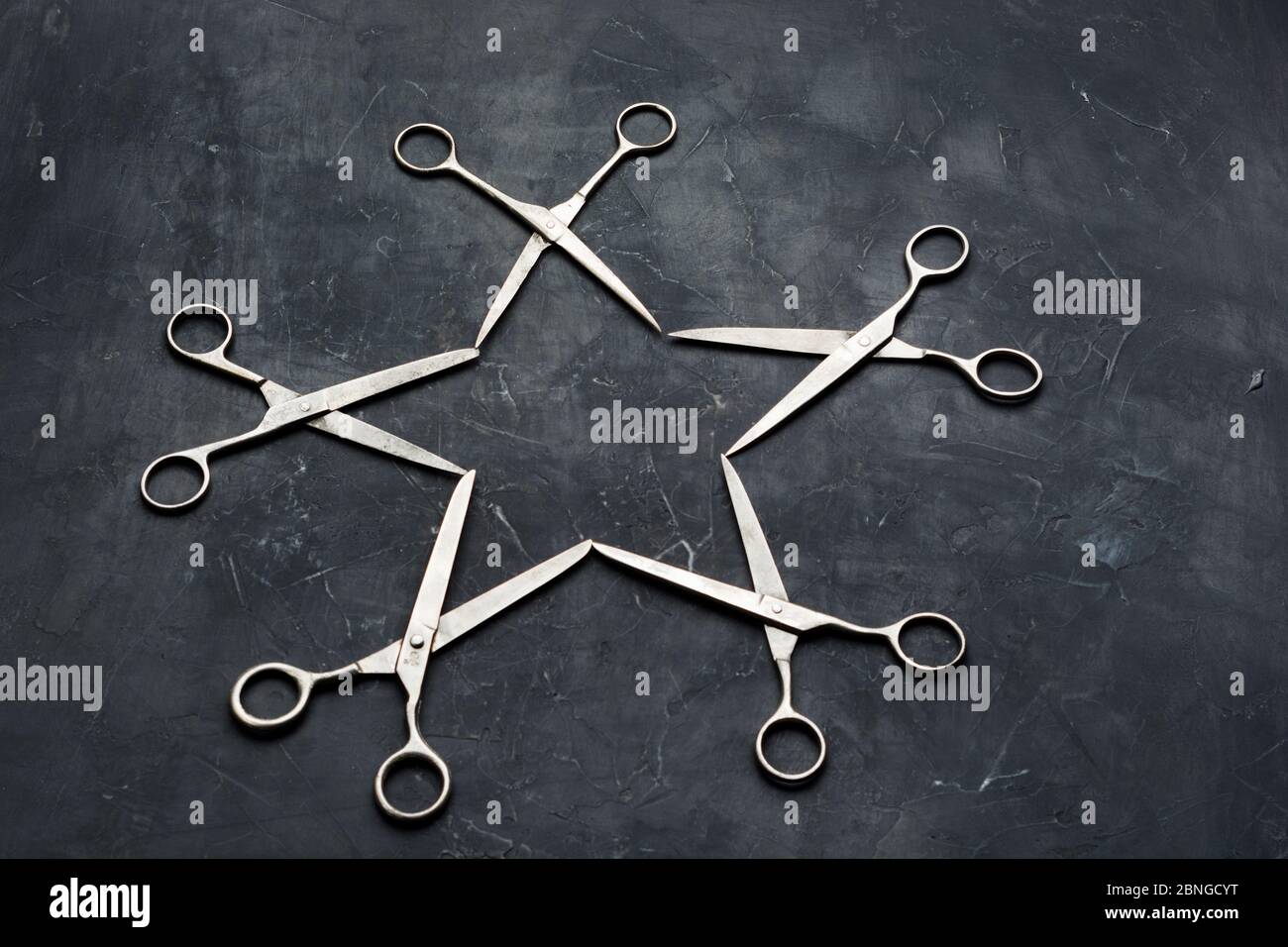 Star make of old scissors on dark background with copy space. Minimal ...