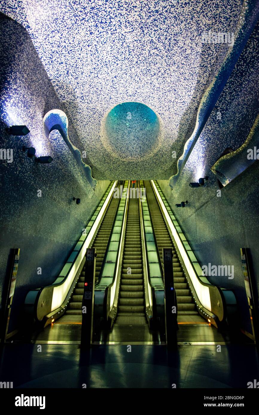 Vertical shot of an escalator with beautiful art design of a ceiling in ...