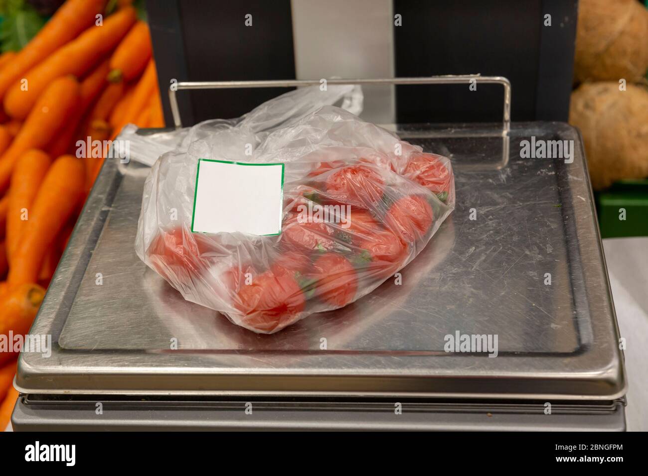 weighing of vegetable on electronic scales in supermarket Stock Photo ...