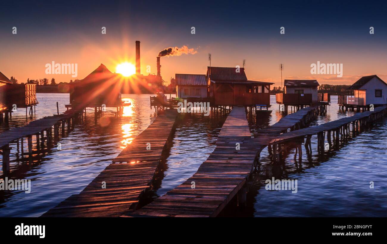 Sunset fishing houses on a lake in Bokod, Hungary Stock Photo - Alamy