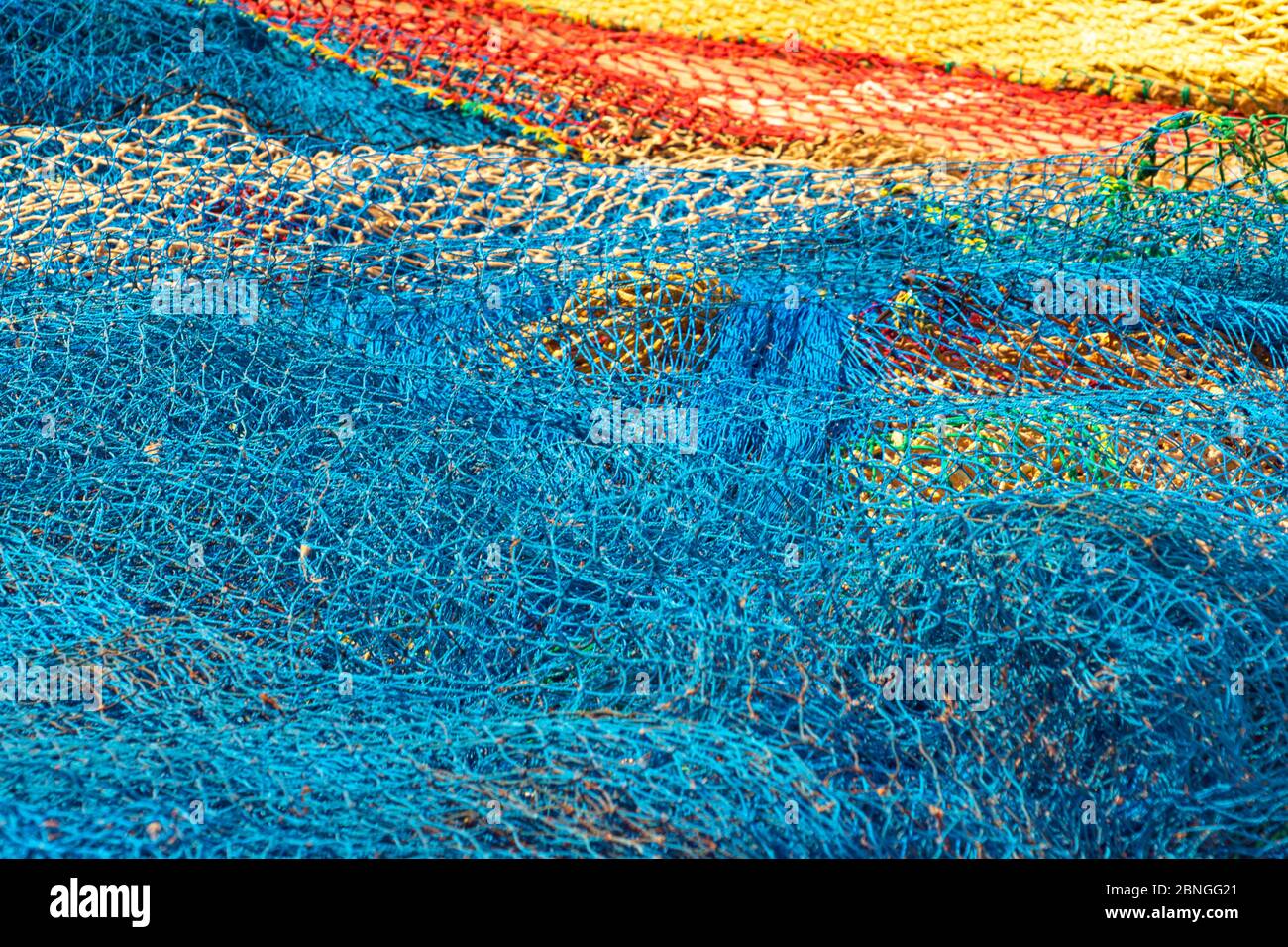 Commercial yellow and blue color fishing nets background Stock Photo - Alamy
