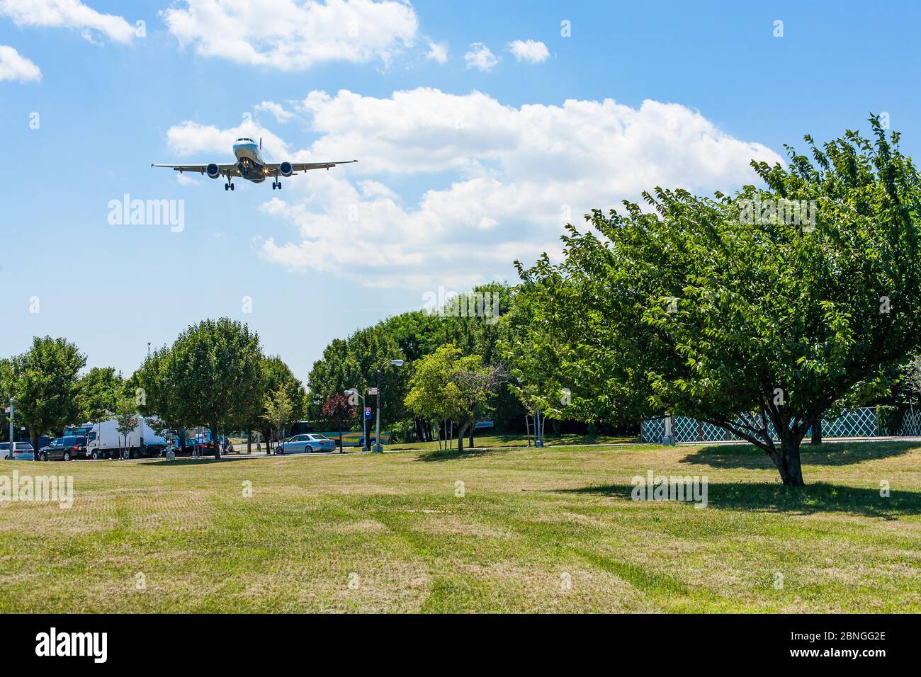 Airplane flying over the green valley Stock Photo - Alamy