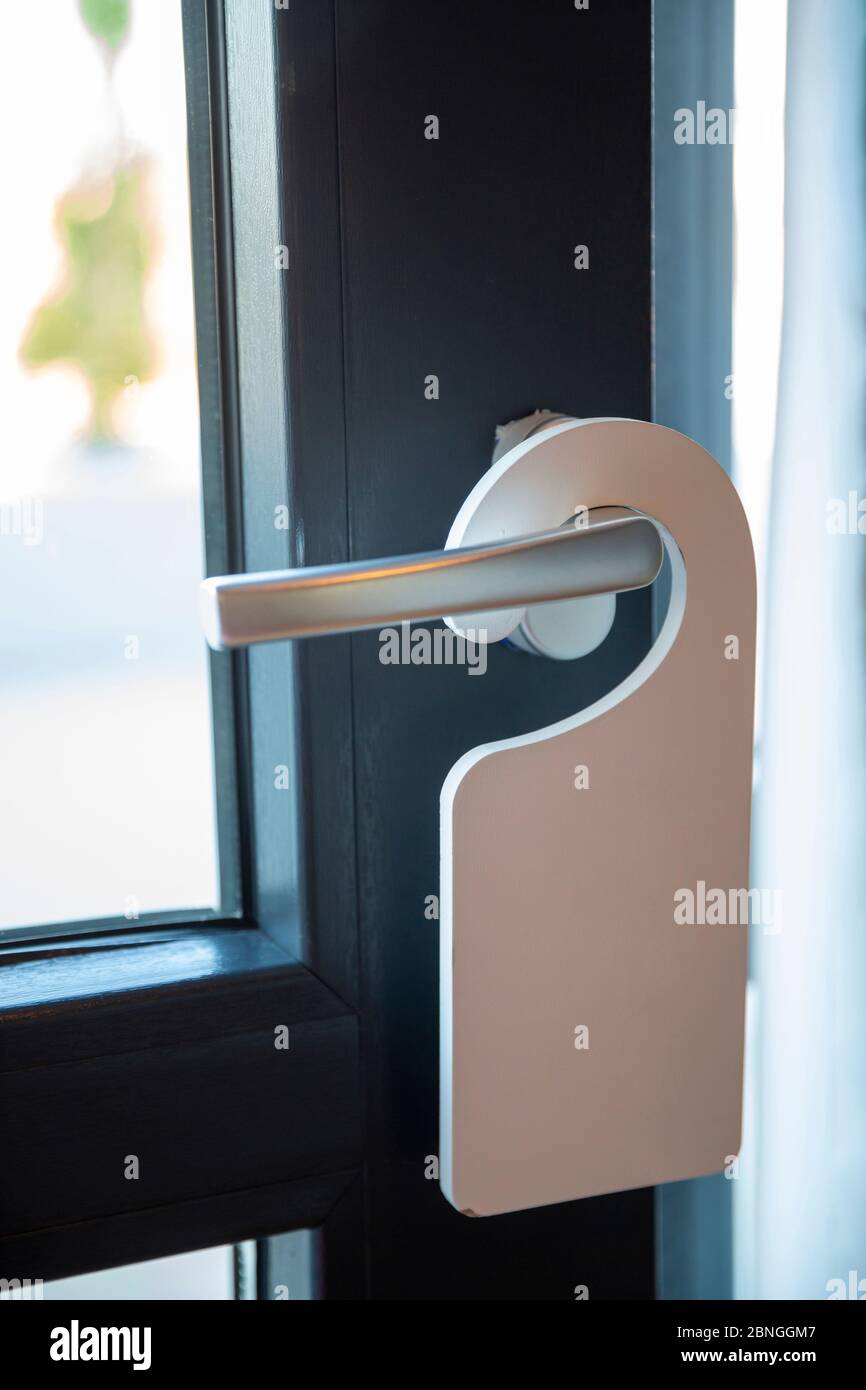 Paper signboard hanging on a handle of door Stock Photo - Alamy