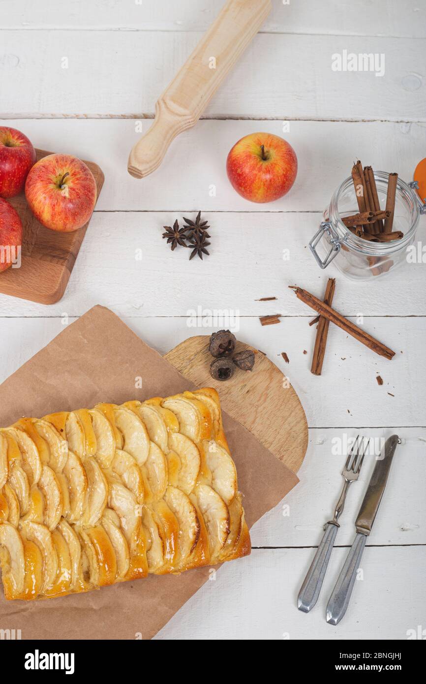 Apple pie with brioche dough on white rustic wooden background. Top ...