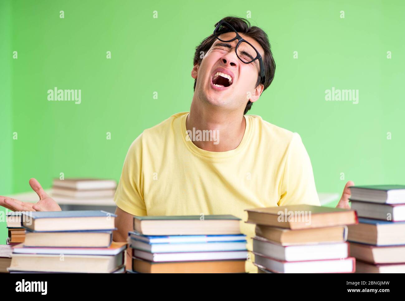 The student with too many books to read before exam Stock Photo - Alamy