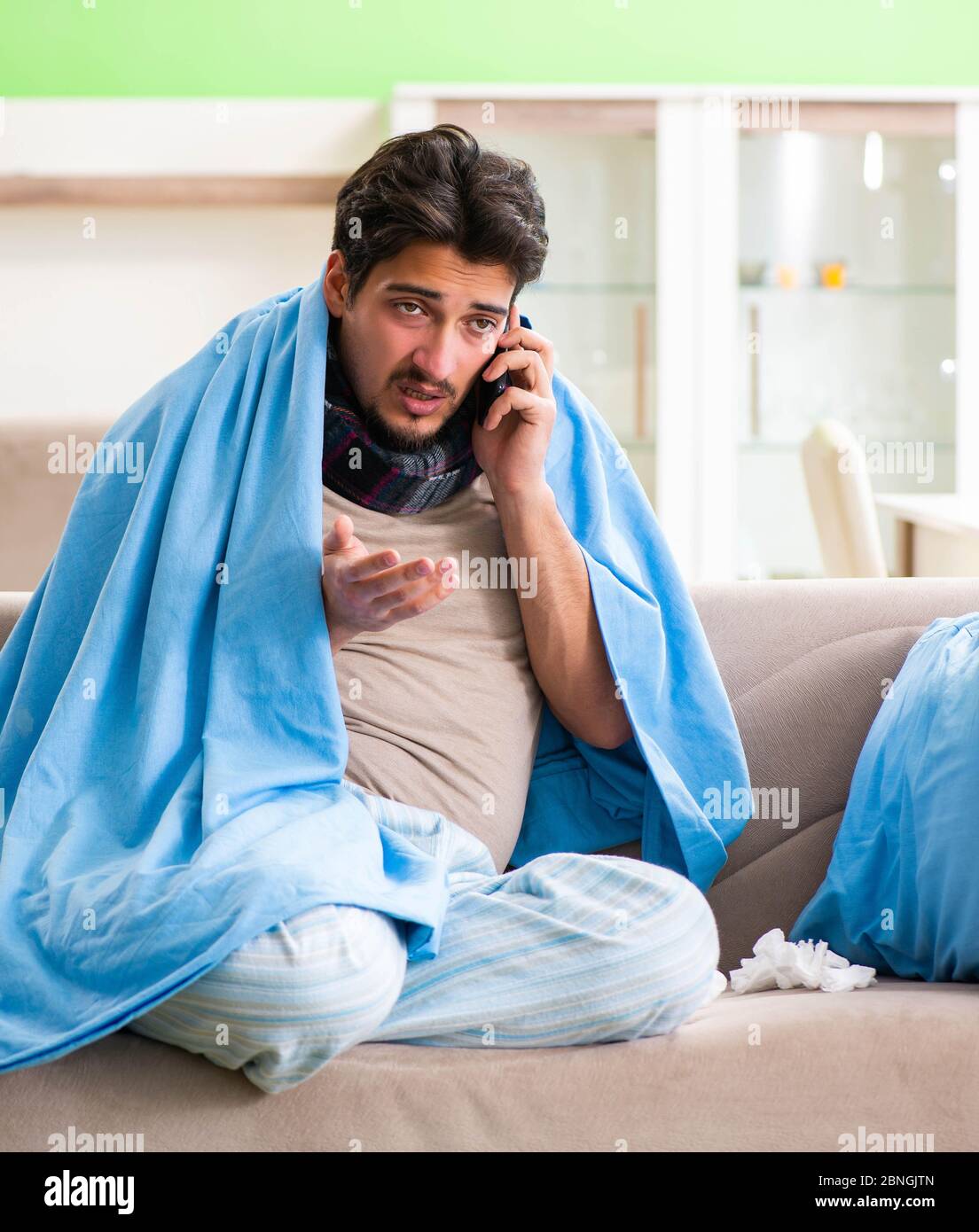 The sick young man suffering from flu at home Stock Photo - Alamy