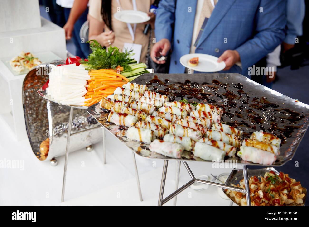 men in blue suits choosing food at a banquet Stock Photo - Alamy