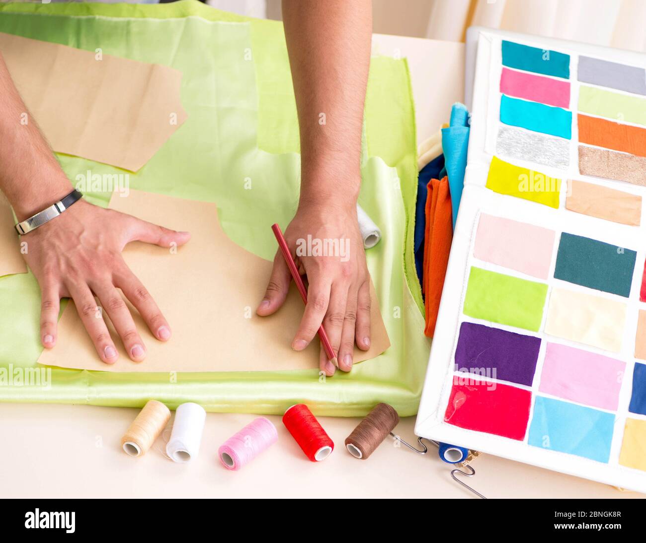 The young handsome tailor working in his workshop Stock Photo - Alamy