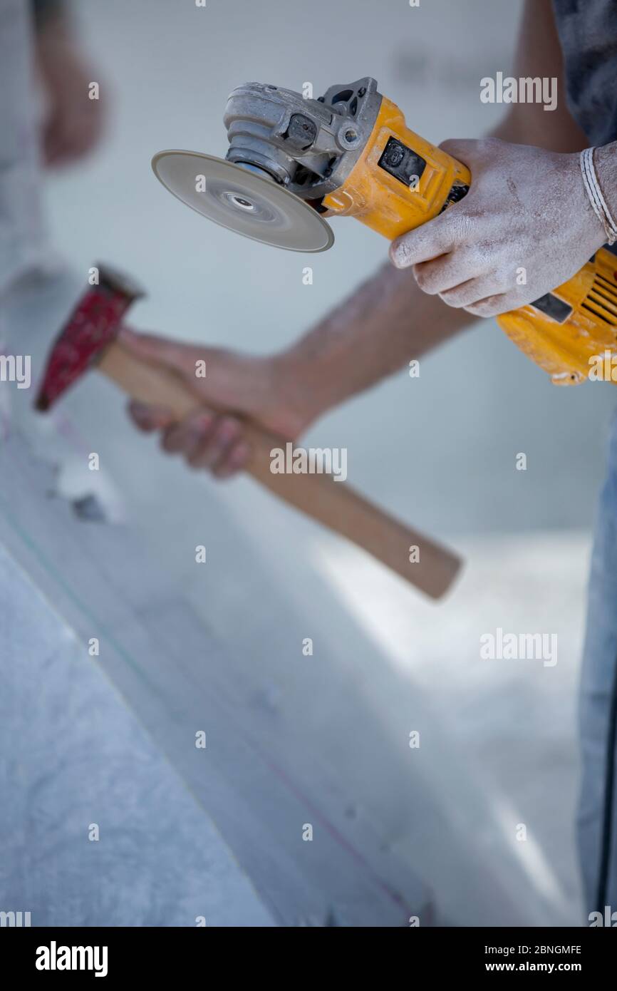 worker cutting stone with grinder Stock Photo - Alamy