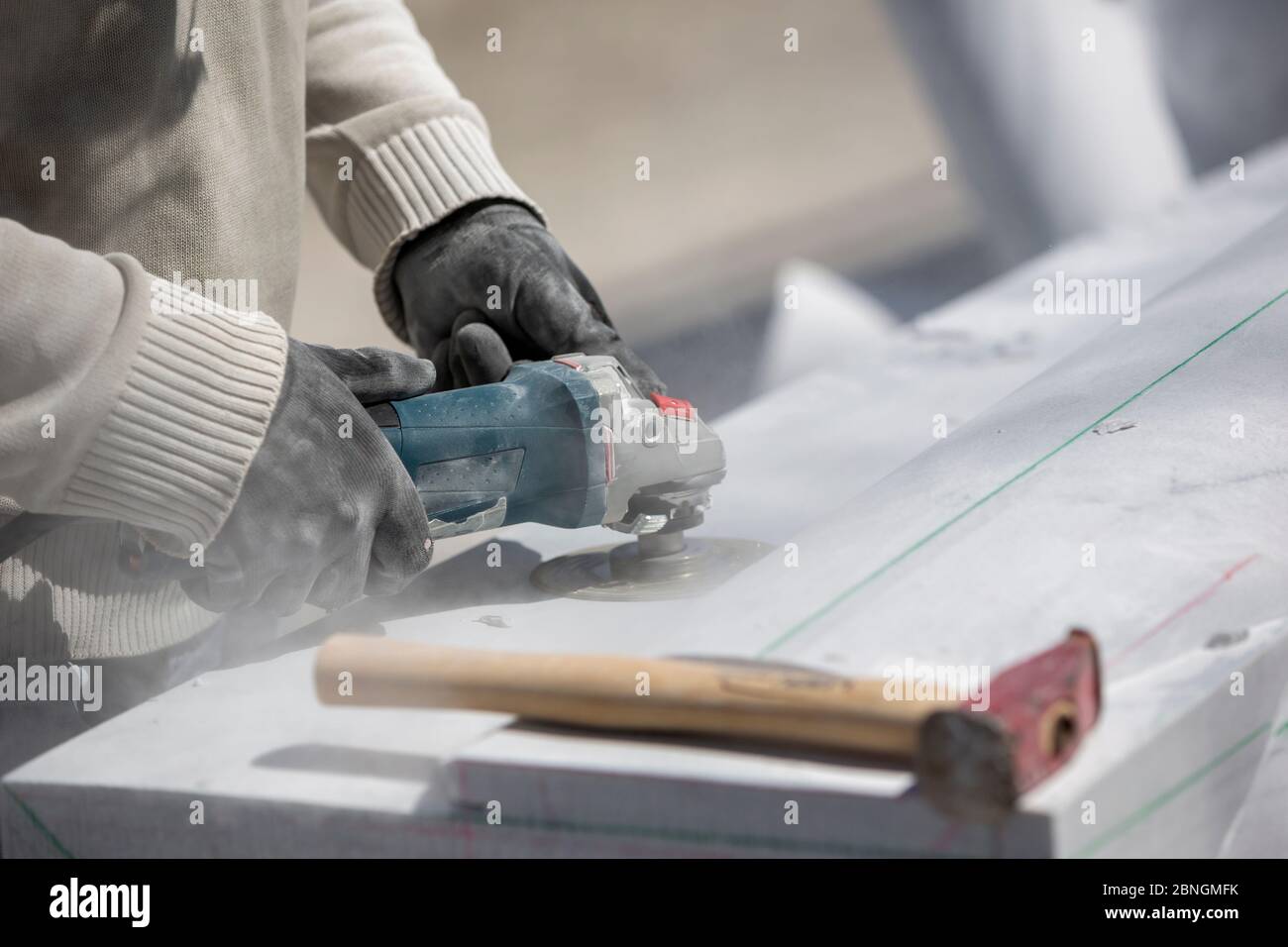 worker cutting stone with grinder Stock Photo - Alamy