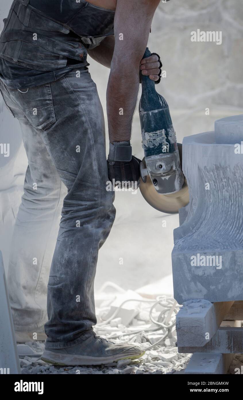 worker cutting stone with grinder Stock Photo - Alamy