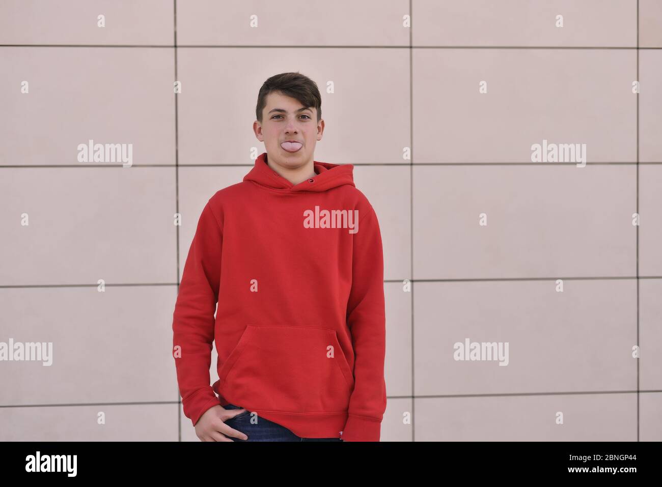 portrait of smiley teenager. dressing in a red shirt Stock Photo - Alamy