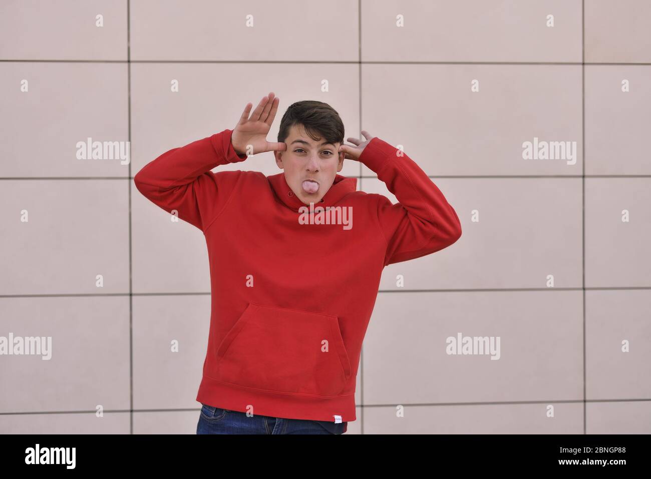 portrait of smiley teenager. dressing in a red shirt Stock Photo - Alamy