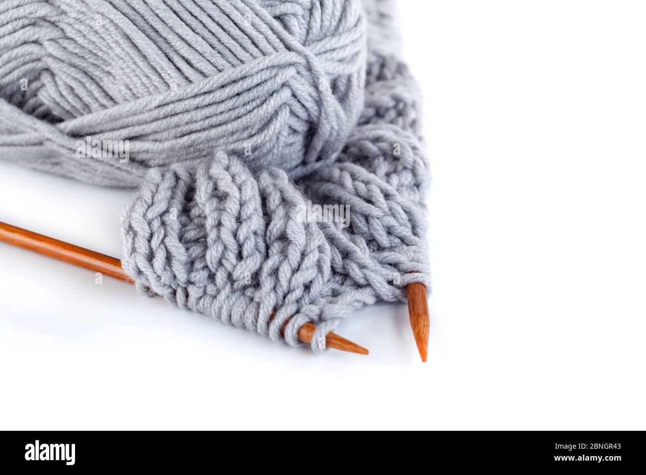 knitting needles and grey and yellow woolen threads isolated on white ...