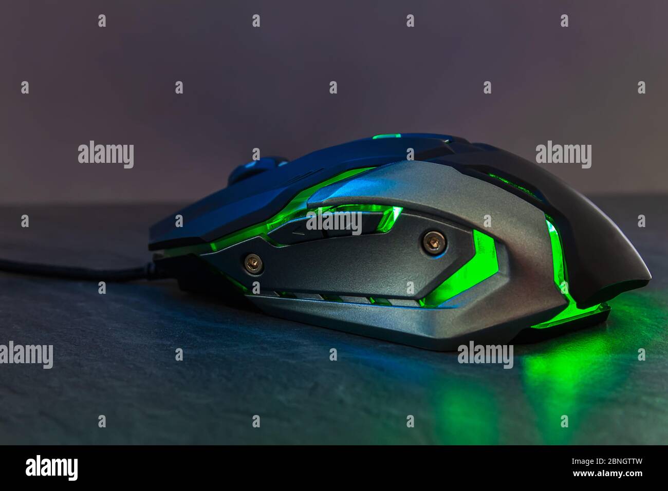 Green gaming mouse on stone texture table Stock Photo - Alamy