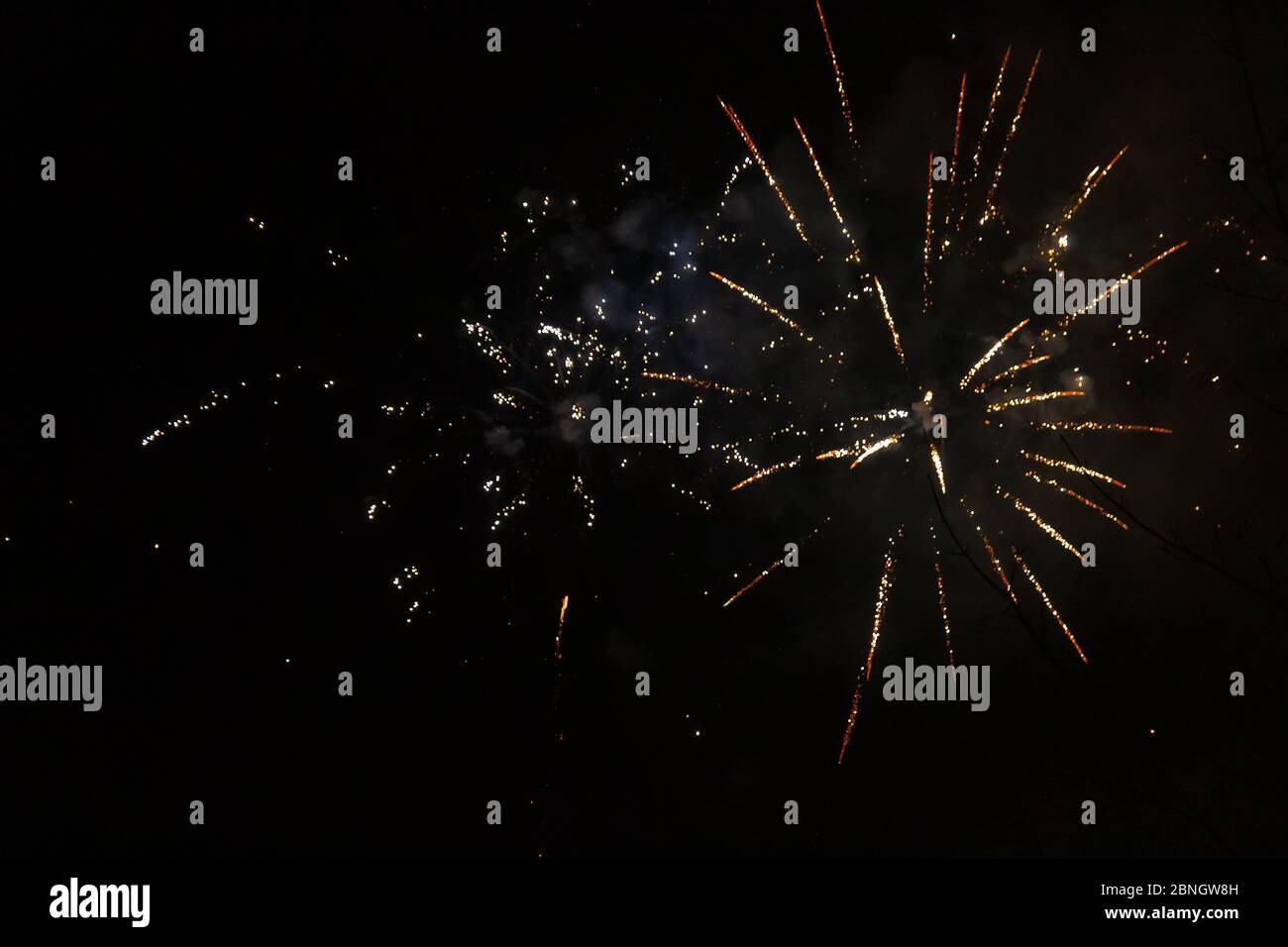 Amazing orange colorful fireworks on dark sky. New years eve ...