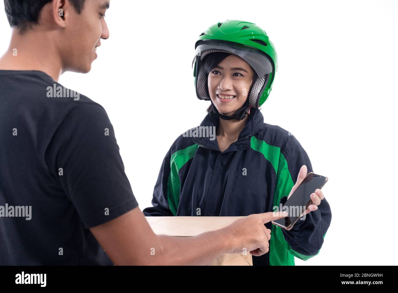 man signing to package he received from delivery courier Stock Photo ...
