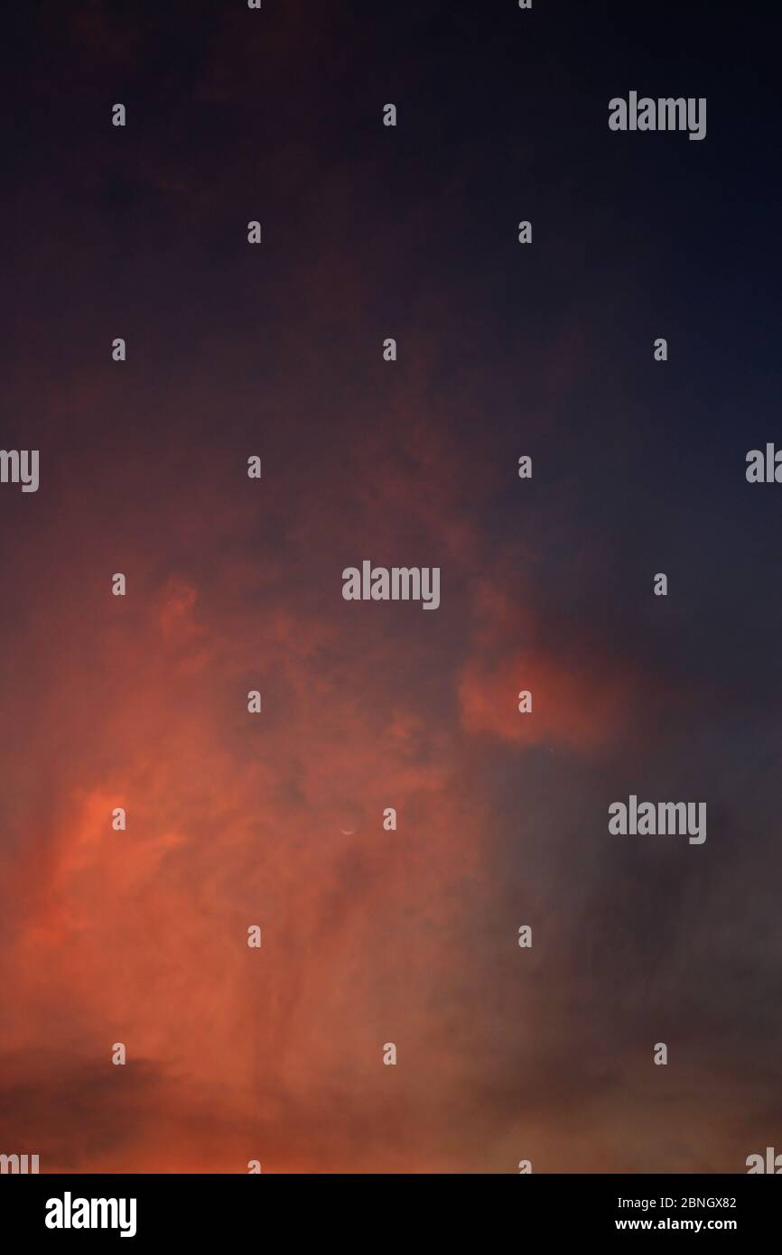 Burning sky, dramatic red colour clouds and sun ray shining through the ...