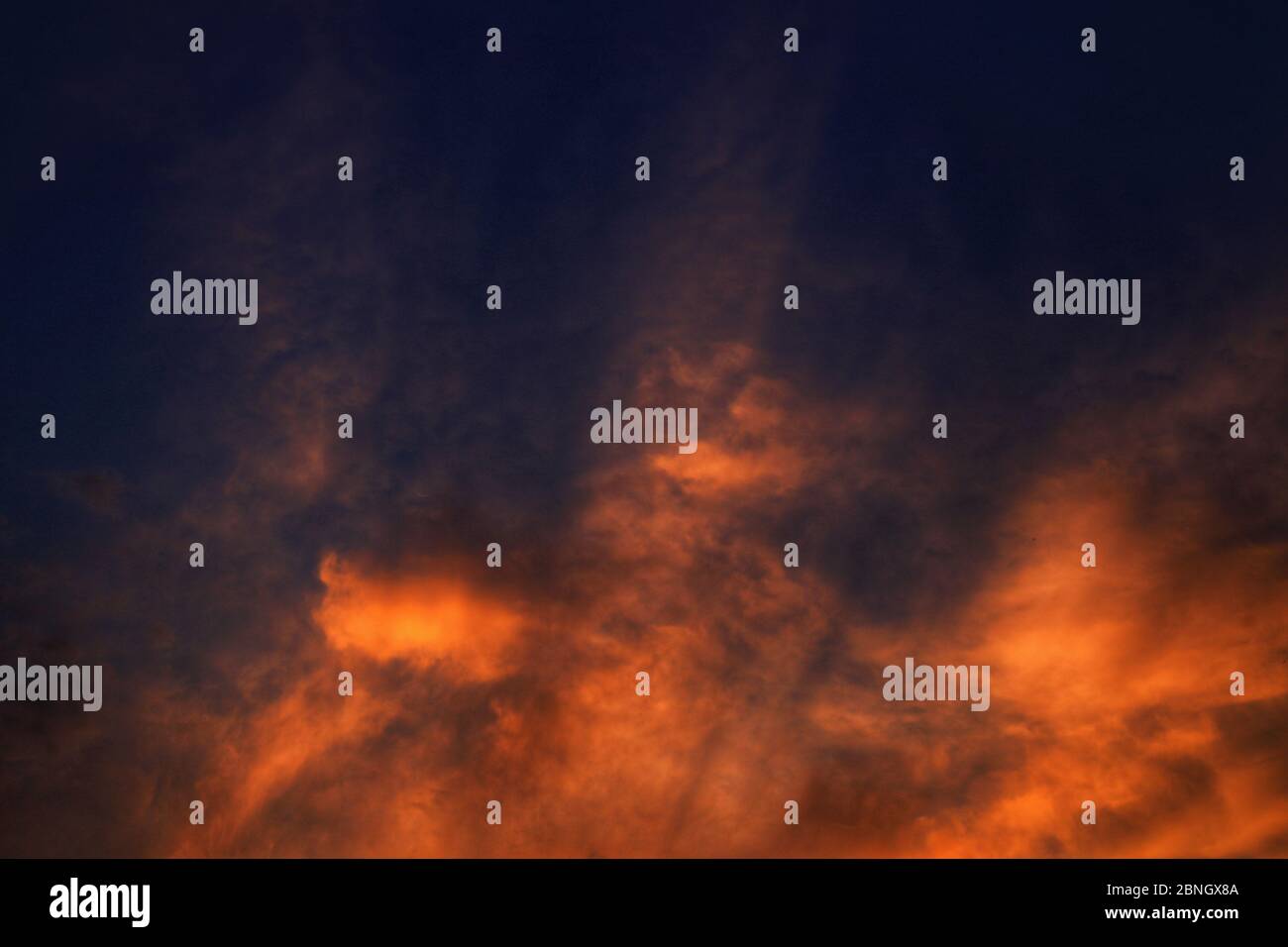 Burning sky, dramatic red colour clouds and sun ray shining through the ...