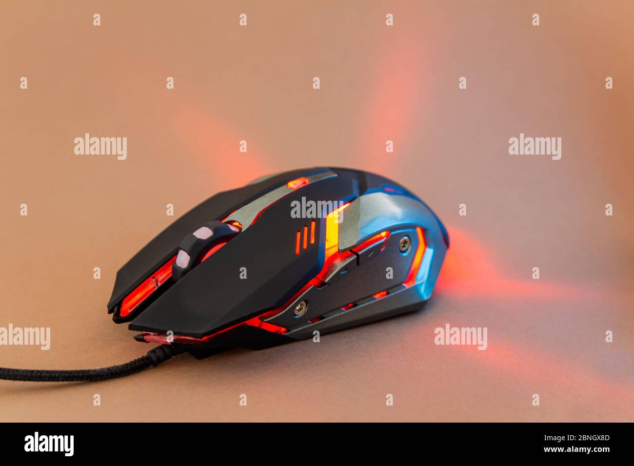 Red shine gaming mouse on brown background Stock Photo - Alamy