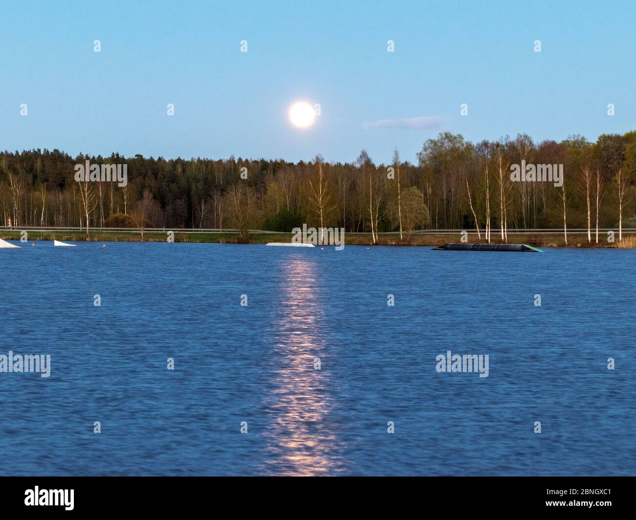 landscape with a moon jump over the lake, the water is marked by a moon ...