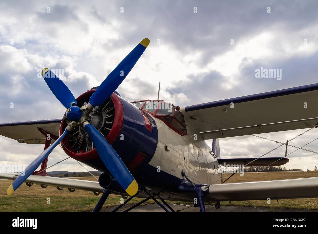 White biplane standing on airports with cloud sky Stock Photo - Alamy