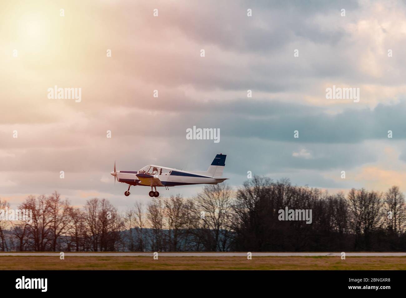 Ultralight plane take off from runway on airports with cloud sky and ...