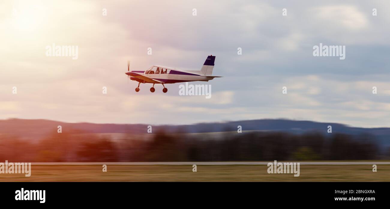 Ultralight plane take off from runway on airports with cloud sky and ...