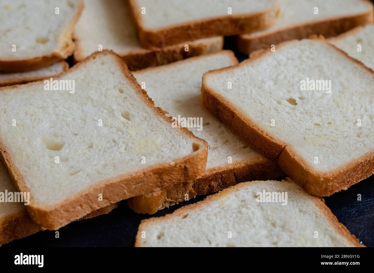 Sandwich bread background. Rectangular pieces of bread pile on the ...