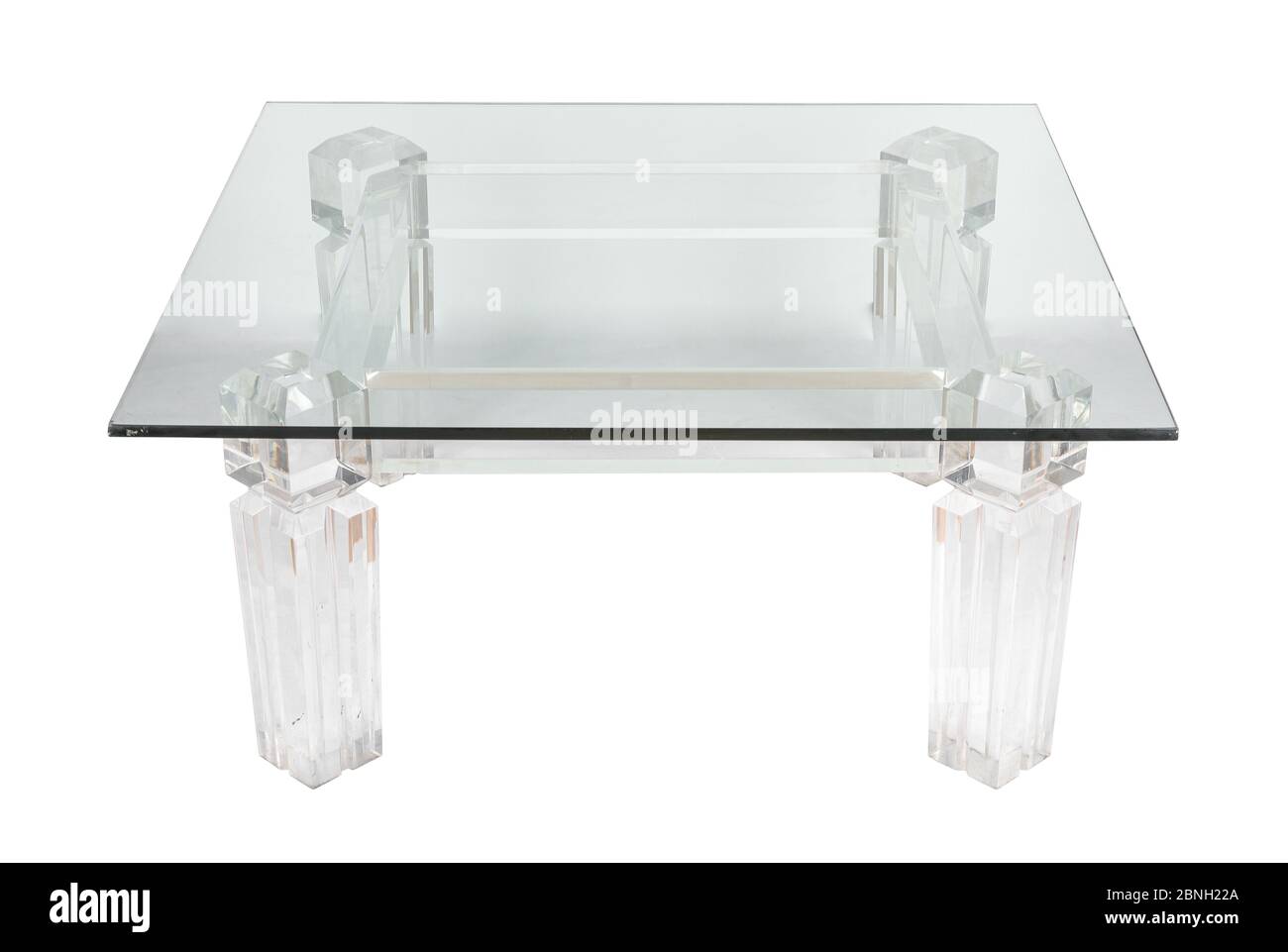 Modern glass table under the lights isolated on a white background ...
