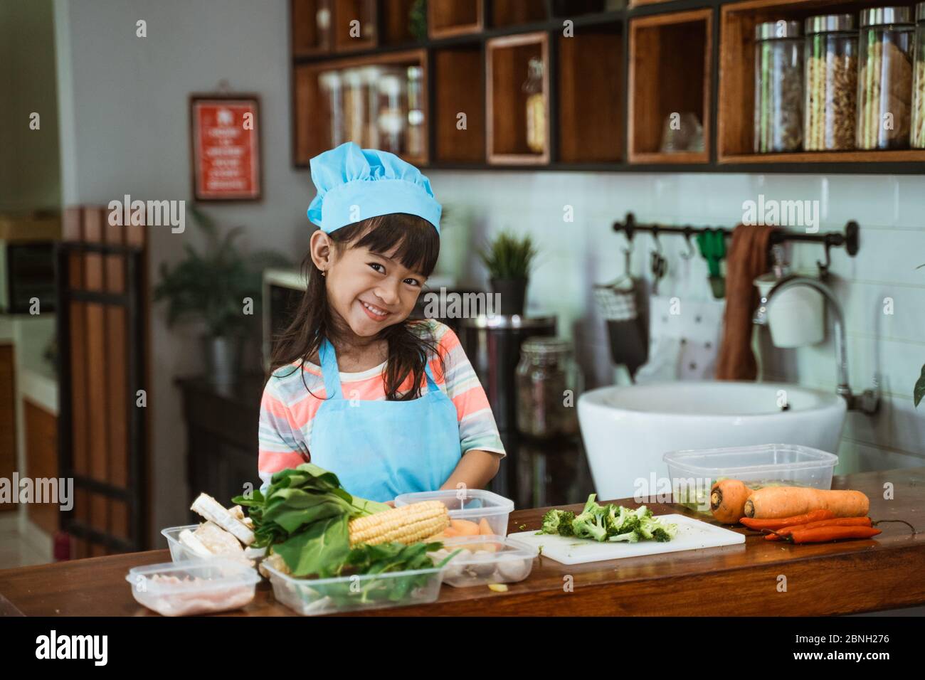 portrait of asian kid learning to cook at home Stock Photo - Alamy