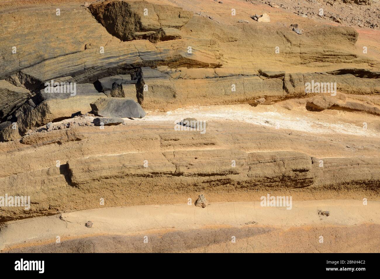 Volcanic rocks with layers formed by layers of volcanic ash, pumice and lava from successive ...