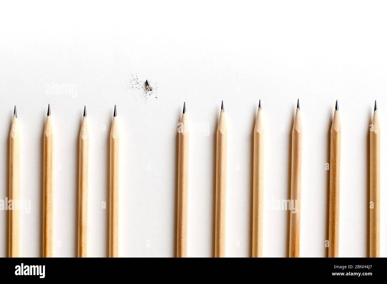 Side view of row of even beautiful sharpened pencils lying on white ...